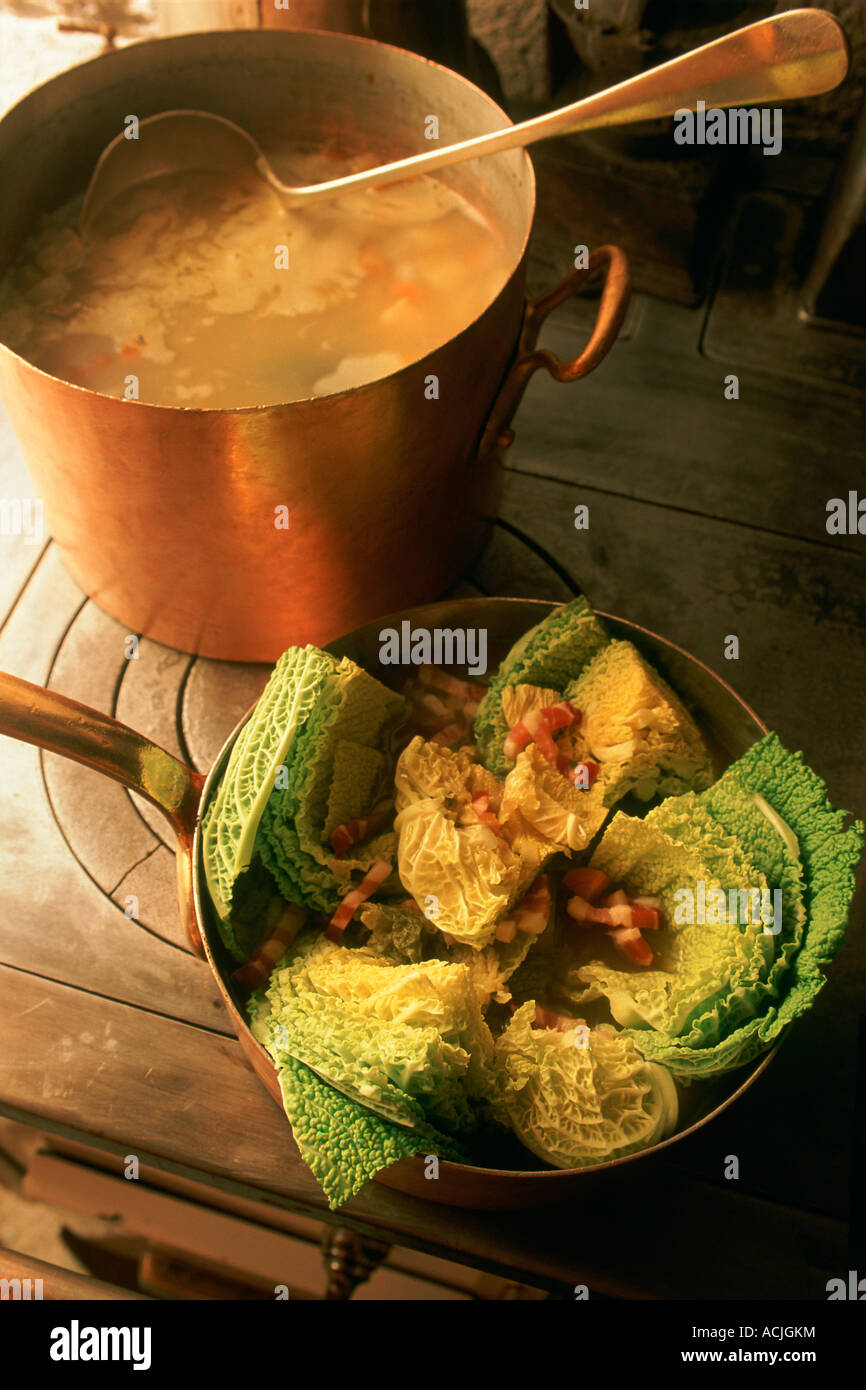 Green cabbage and thinly sliced bacon cooked in copper casserole soup ...