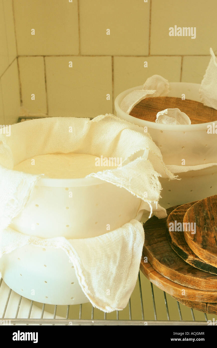 Cheese making cheese running in cheese strainer wooden board paving in ...