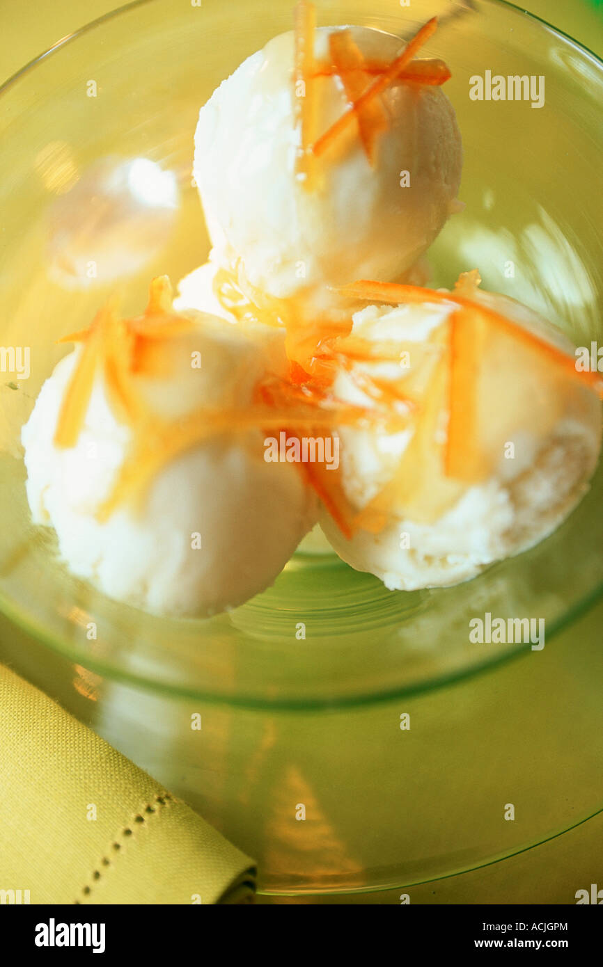 Ice cream in glass cup candied lemon zest yellow/green background Stock ...
