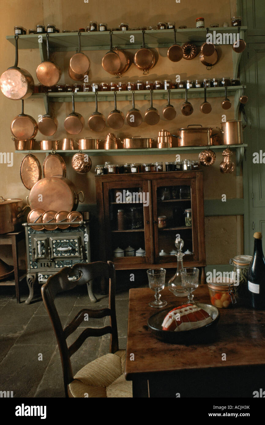 Ancient room joint and potted vegetables on table jam pots and copper ...