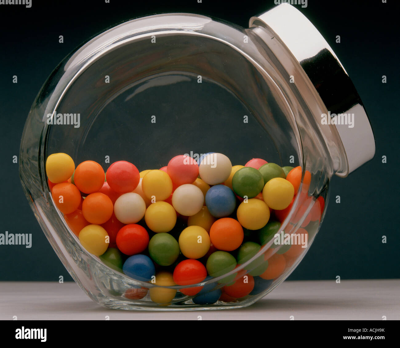 Jar filled with multi-coloured chew-gums Stock Photo - Alamy
