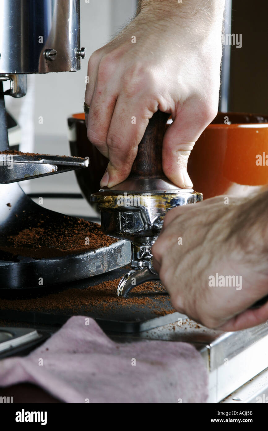 Tamping the espresso after dosing and leveling Stock Photo - Alamy