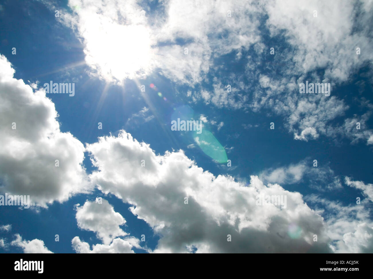 Sun on partial cloudy sky Stock Photo - Alamy