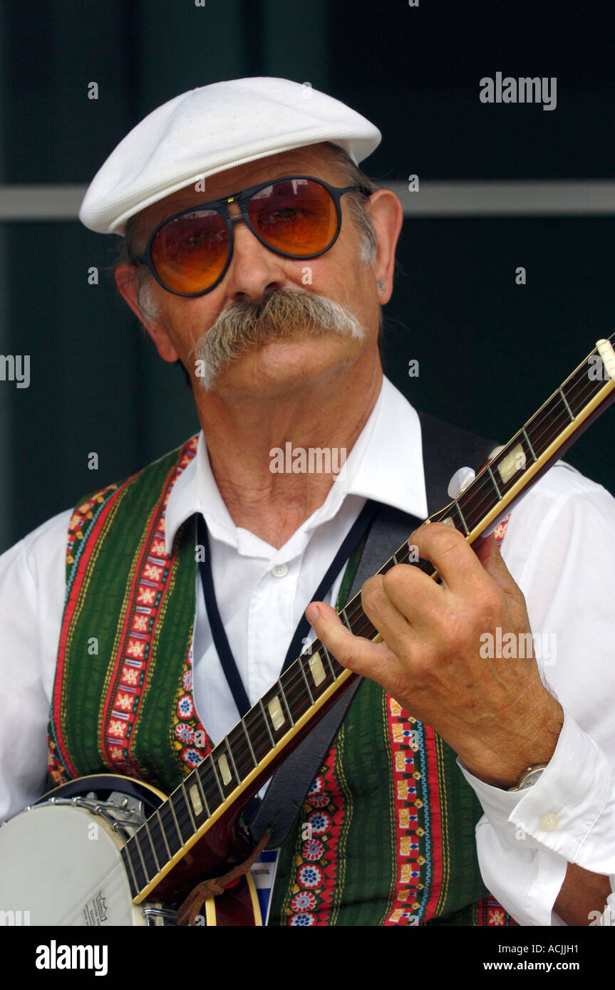 Musician with handlebar mustache playing the banjo Stock Photo - Alamy