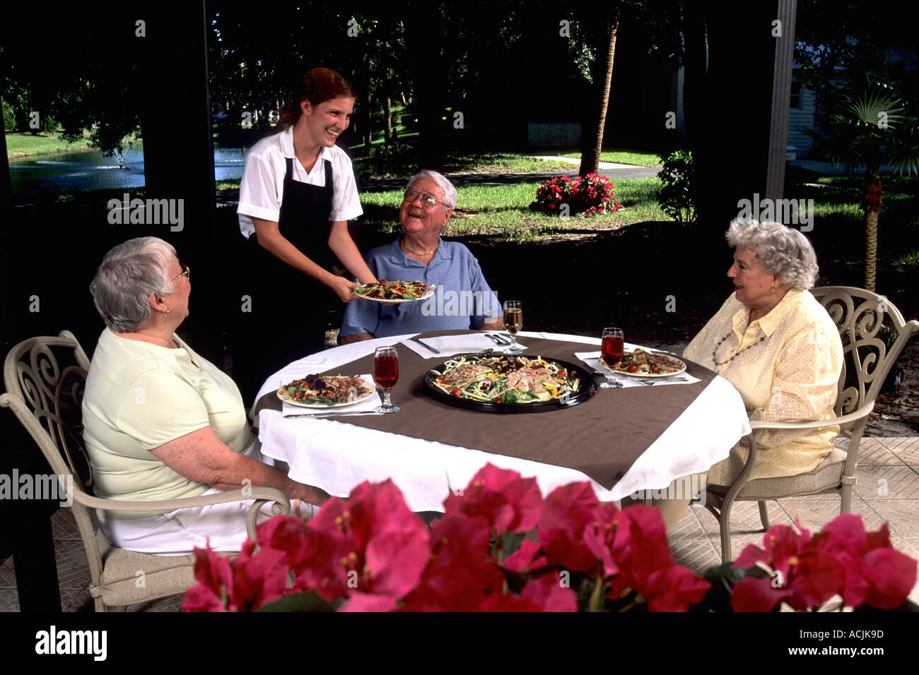 Healthy retired seniors having dinner at outdoor café Stock Photo - Alamy