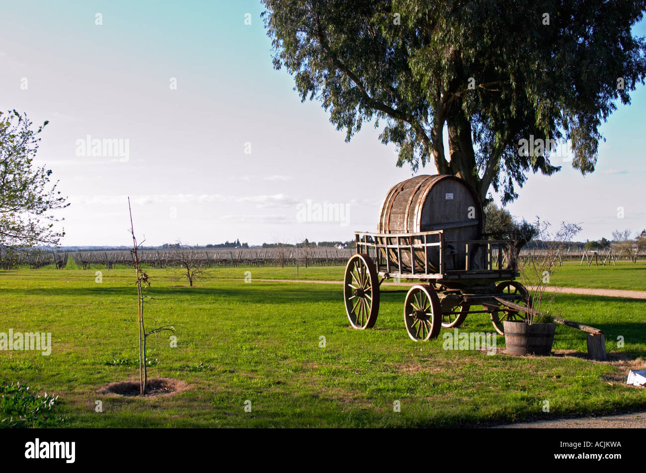 An old horse drawn carriage cart with an old wooden barrel in the ...