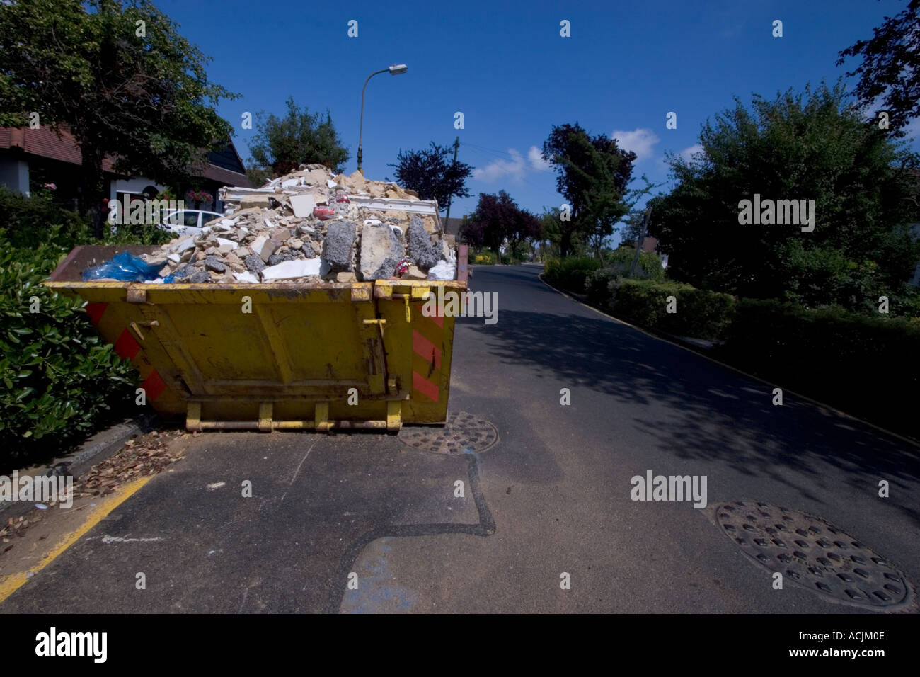 builders skip full of household waste trash and rubble in leafy Essex ...
