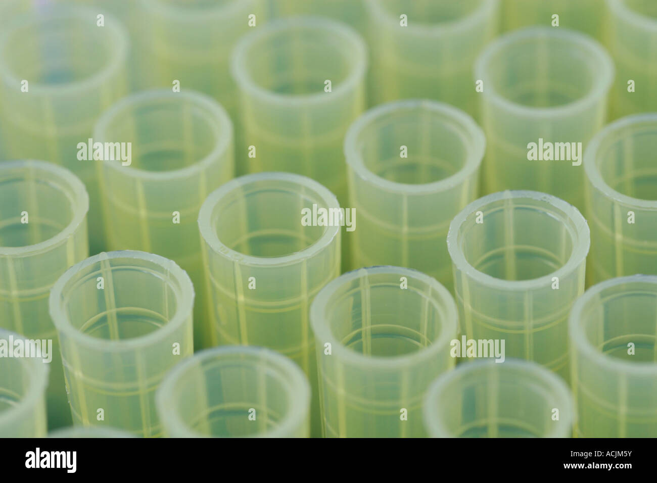 Close up view of a number of yellow pipette tips in a dispensing box ...