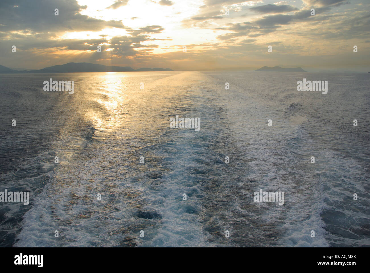 Propeller water turbulence of ships wake in Aegean Sea & sunset above ...