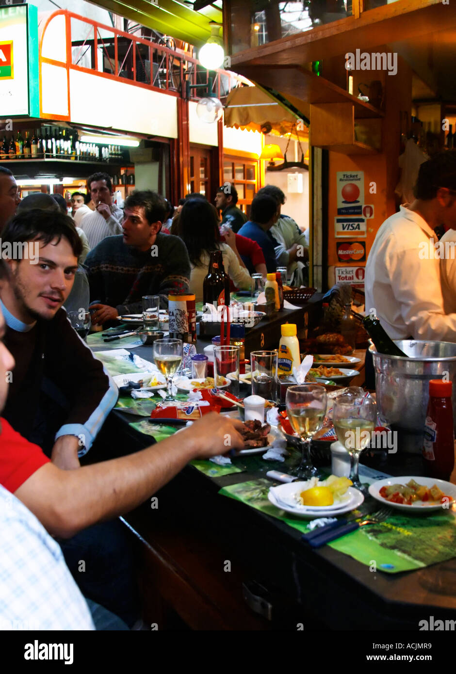 People sitting at the bar drinking and eating at lunch time on a Sunday ...