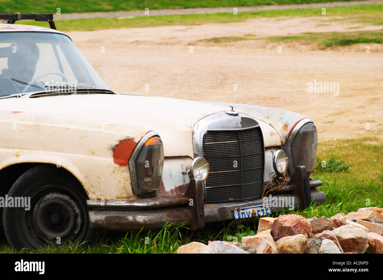 An old classic but run down and rusty Mercedes parked, detail of the ...