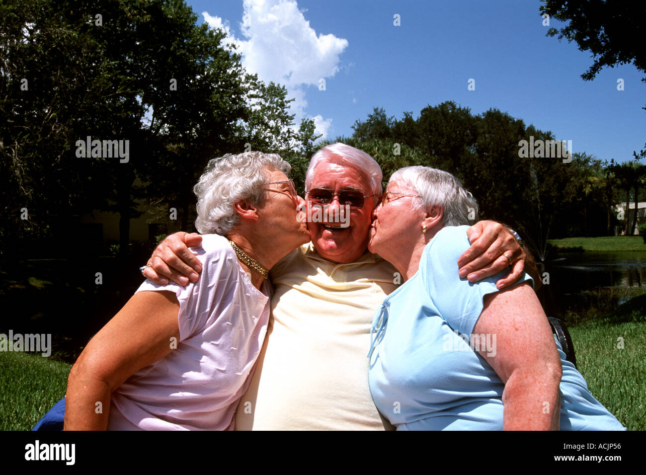 Healthy retired senior couples have fun park on park bench Stock Photo ...