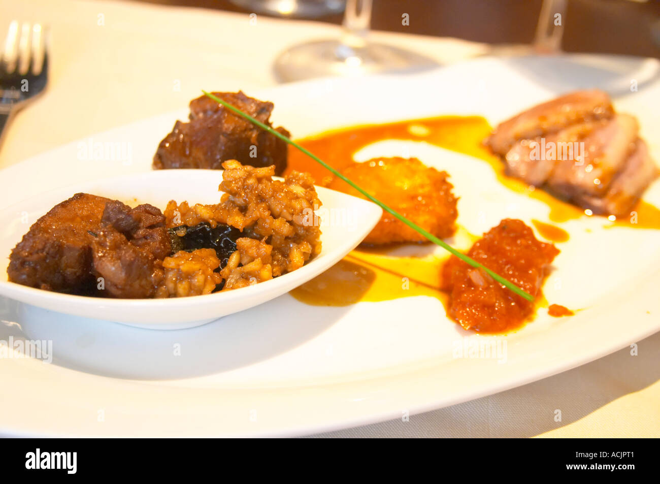 Duck in three different forms with risotto, potato cake and tomato ...