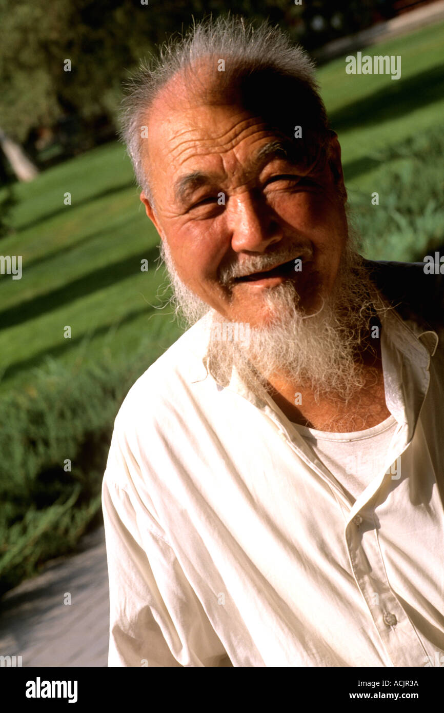 Colorful portrait of elderly Chinese man with beard in Beijing China ...