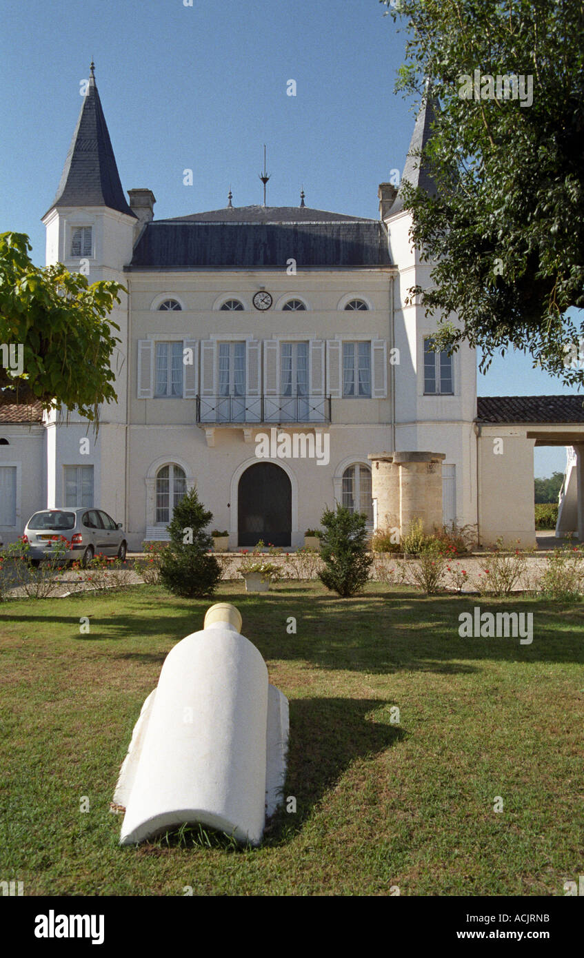 The chateau building with its twin towers and on the lawn in the garden ...