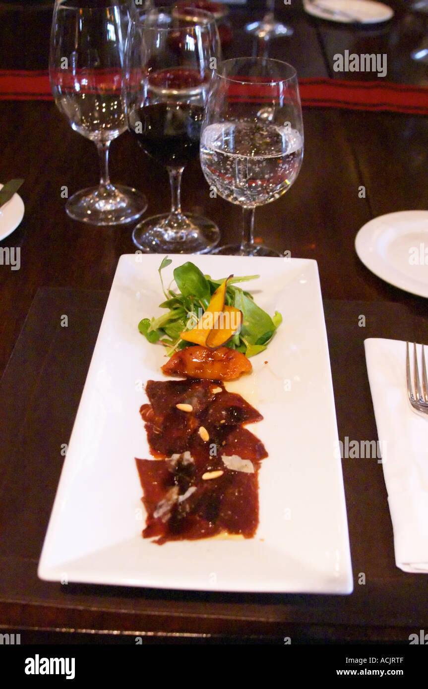 Carpaccio raw marinated beef with pine nuts olive oil balsamic vinegar ...