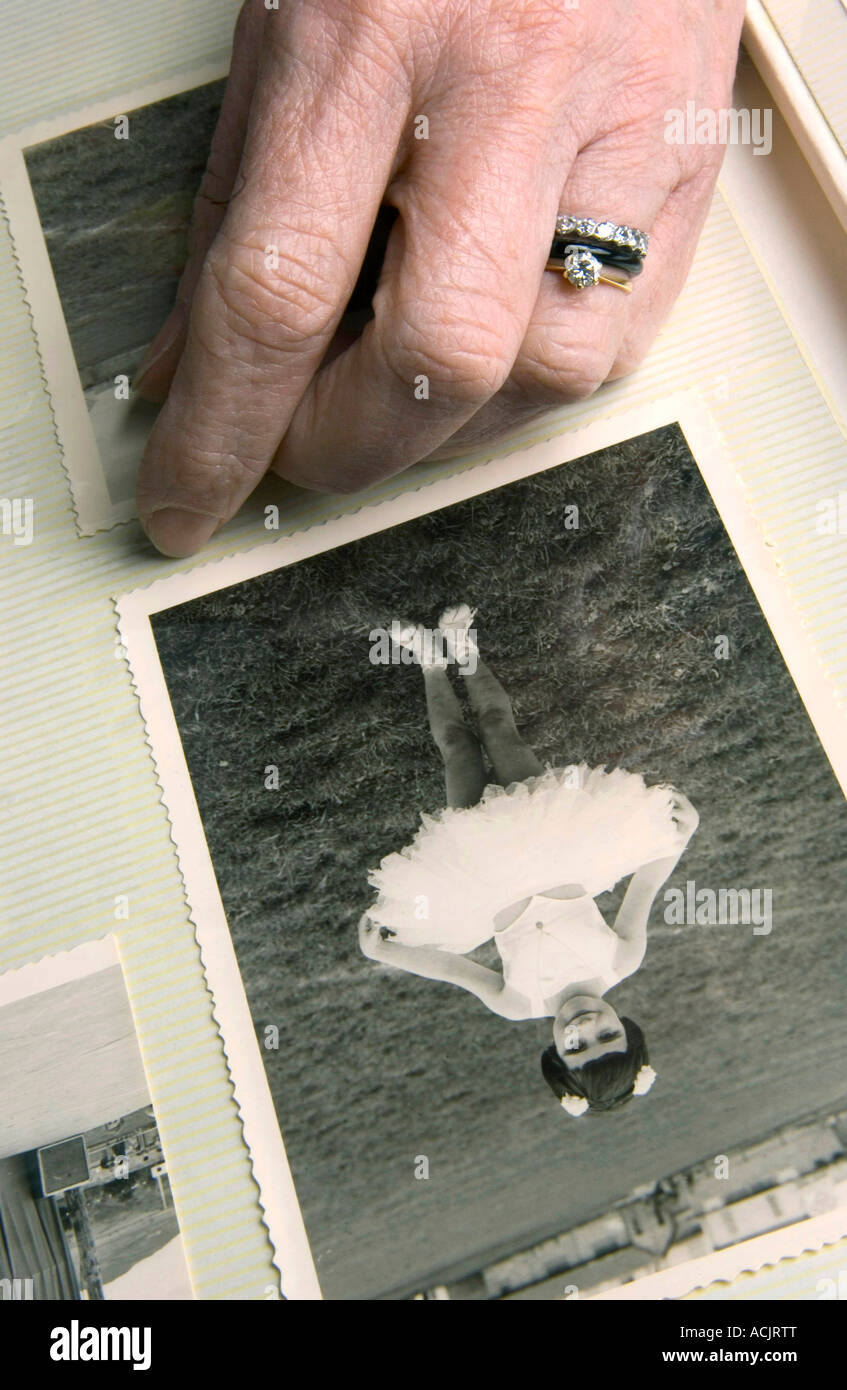 Senior woman's hand on a photo album Stock Photo - Alamy