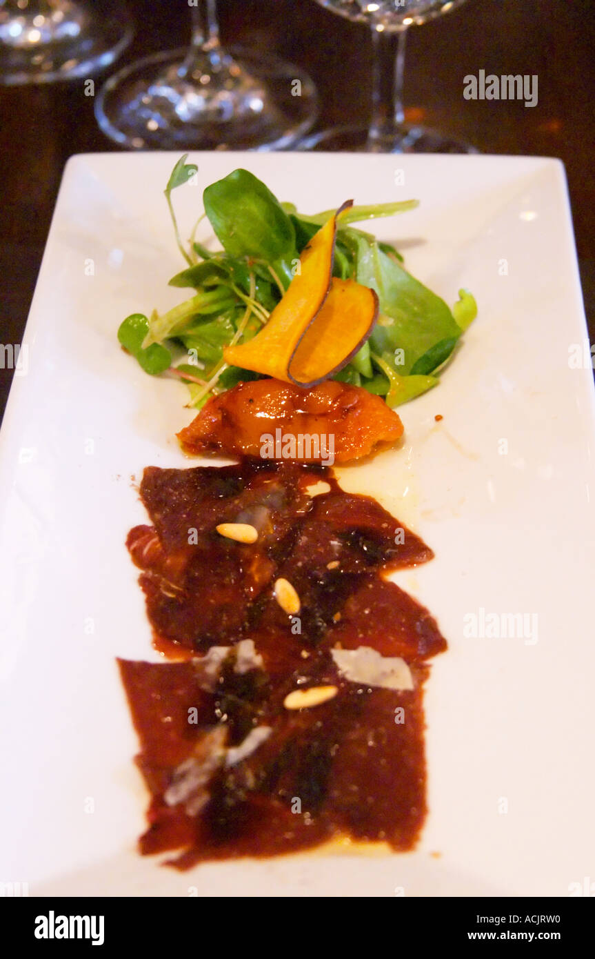 Carpaccio raw marinated beef with pine nuts olive oil balsamic vinegar ...