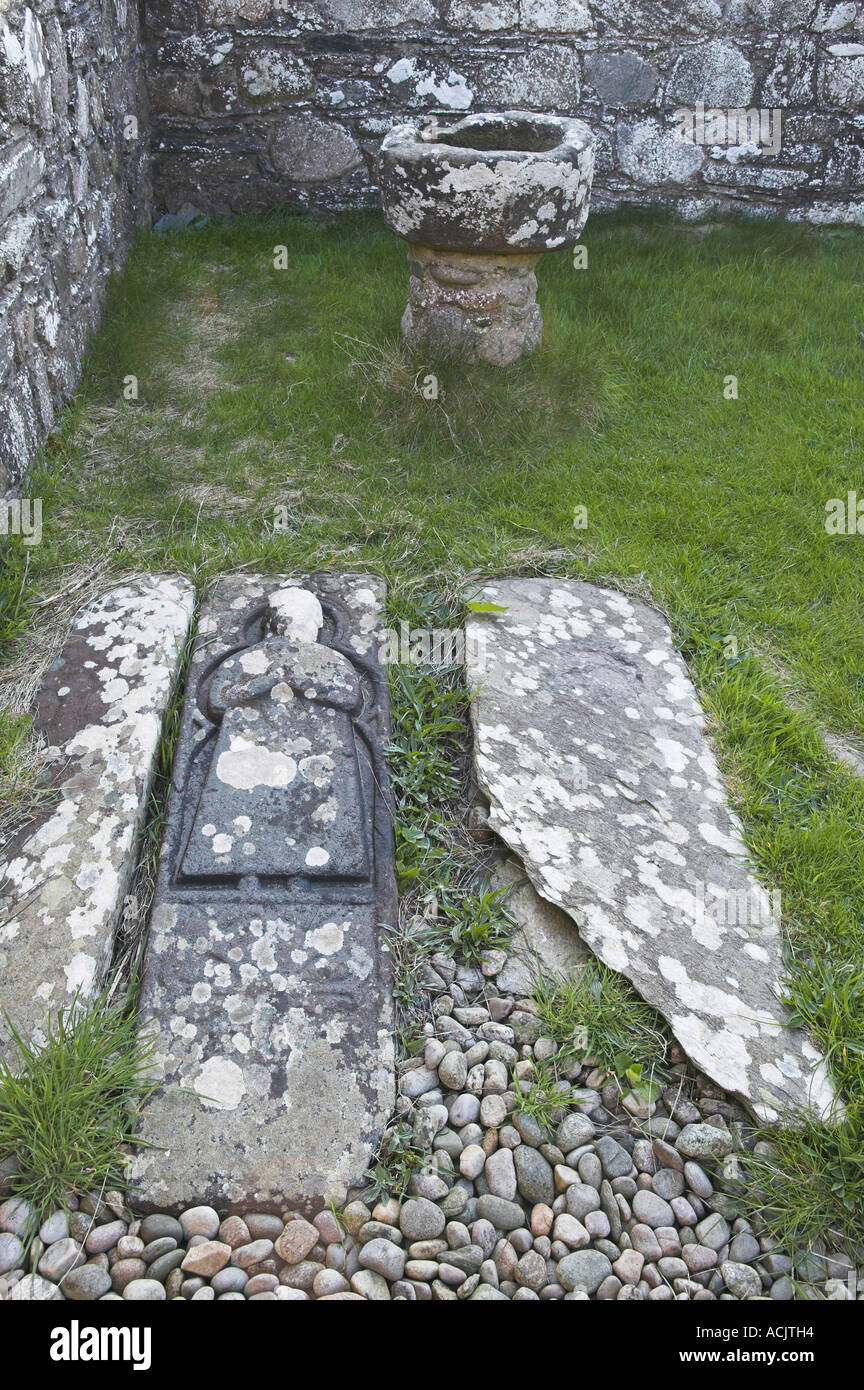 Grave slabs and stone font in Kilchiaran Chapel, Isle of Islay, Argyll ...