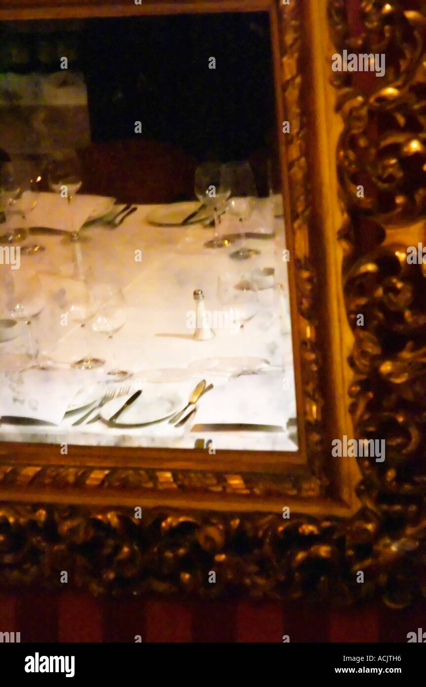 Mirror reflection of the dining table set for guests, mirror in heavy ...