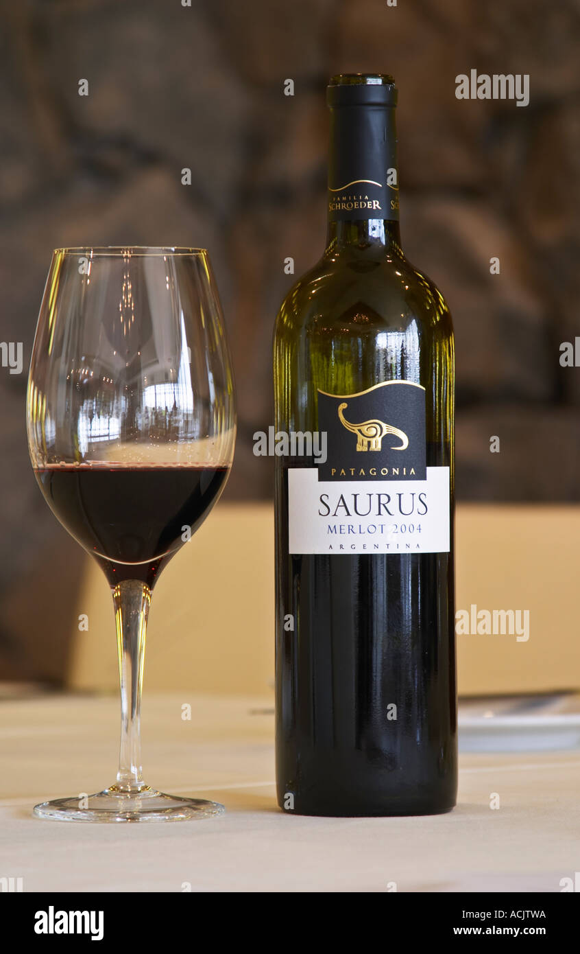 Bottle and glass of Saurus Patagonia Merlot Bodega Familia Schroeder ...
