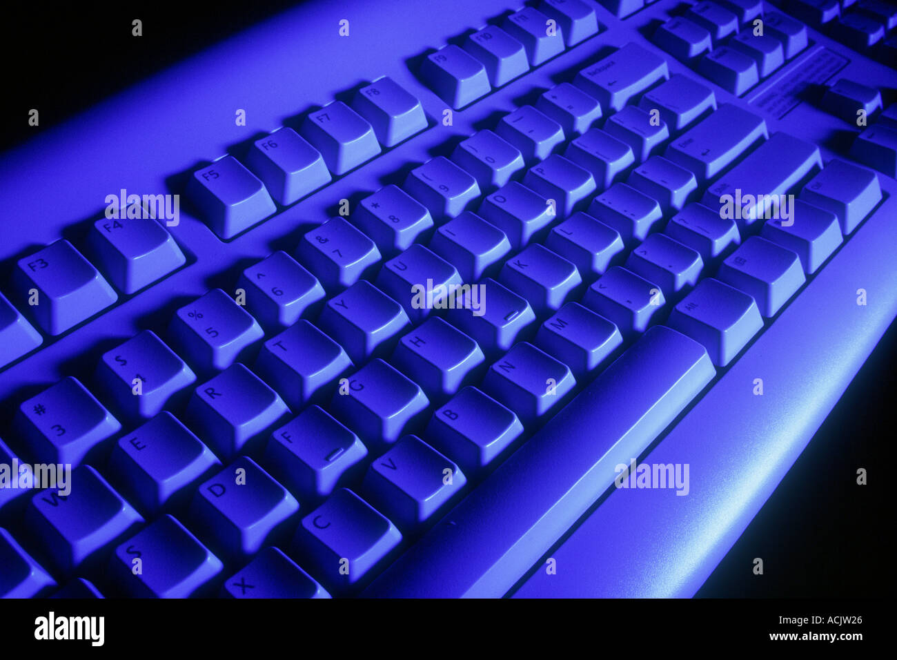 Computer keyboard product shot under blue light Stock Photo - Alamy