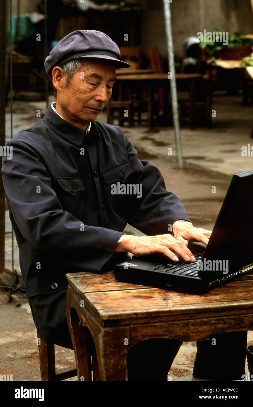 Old Chinese man on laptop computer in Shanghai China Stock Photo - Alamy