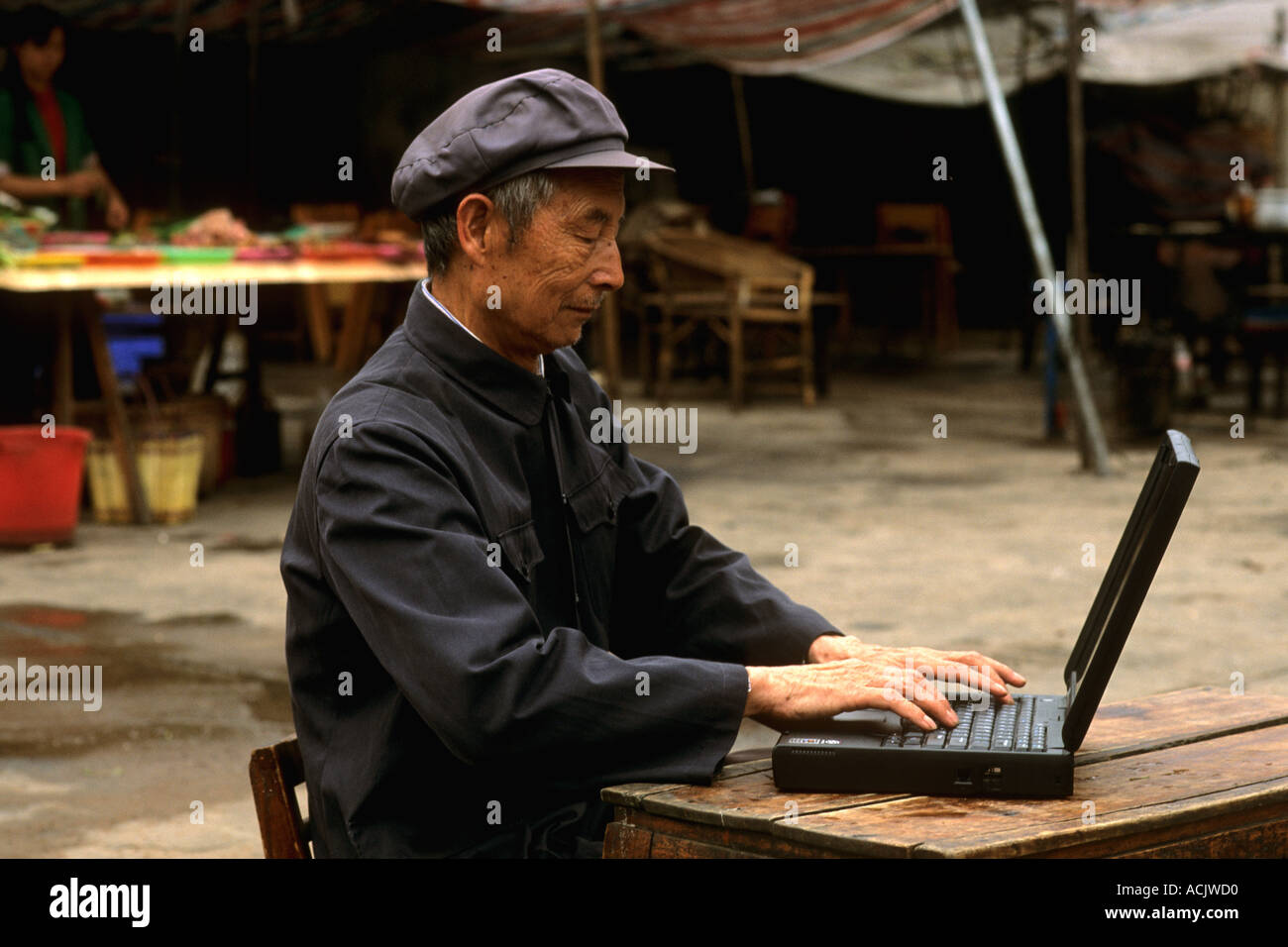Old Chinese man on laptop computer in Shanghai China Stock Photo - Alamy