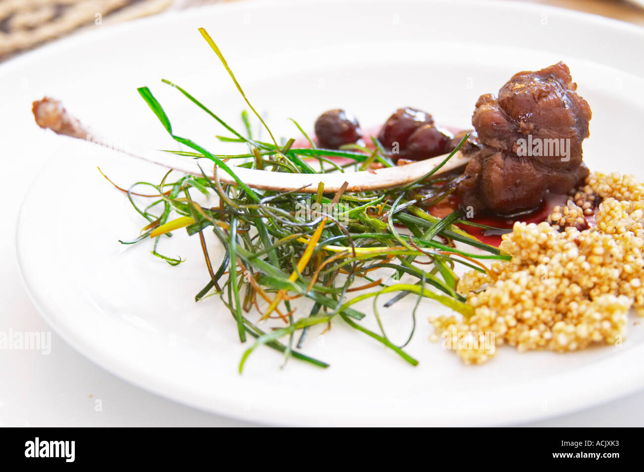 grilled lamb chops with cherry sauce and traditional Inca grain grown ...