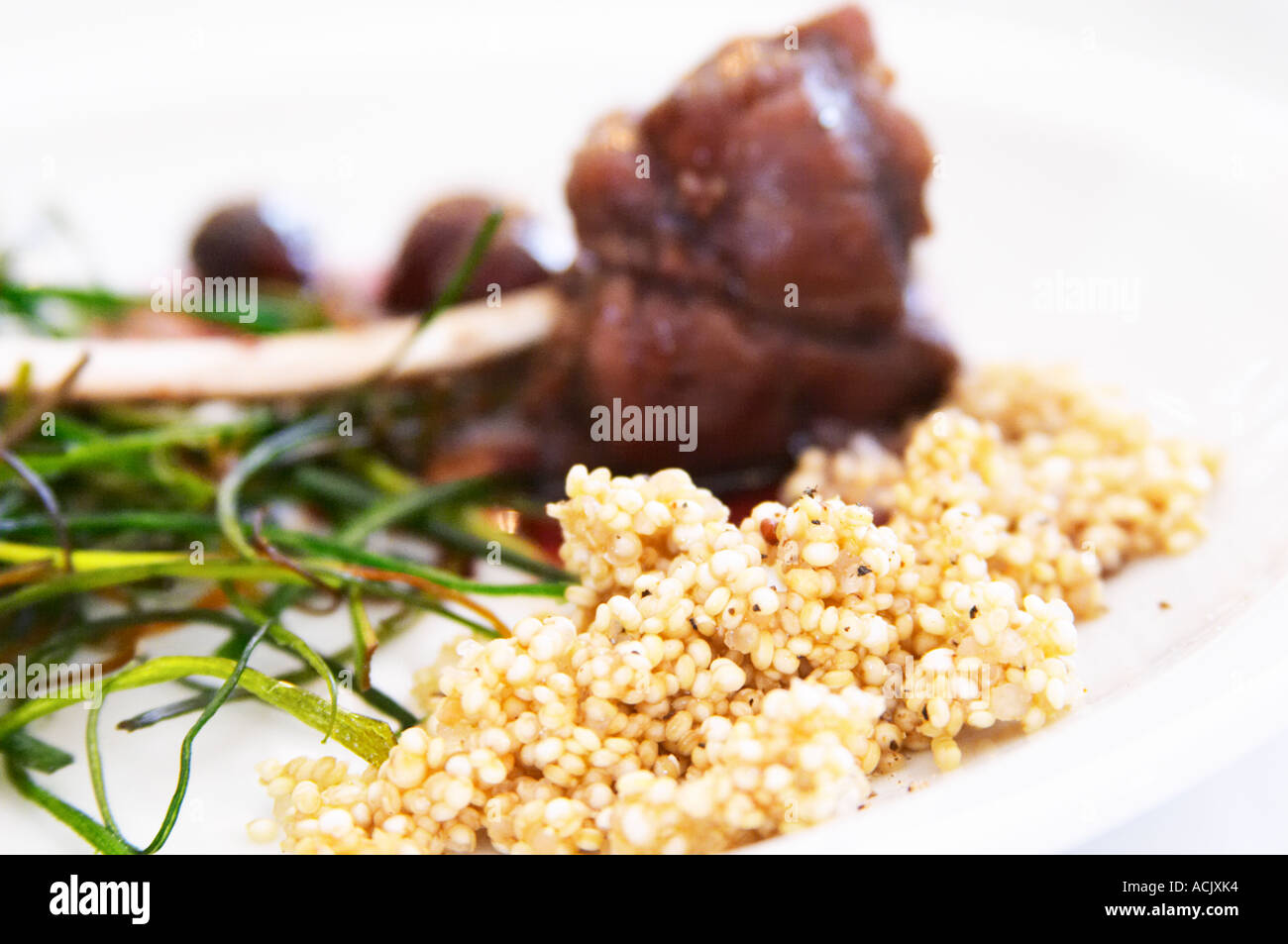 grilled lamb chops with cherry sauce and traditional Inca grain grown ...