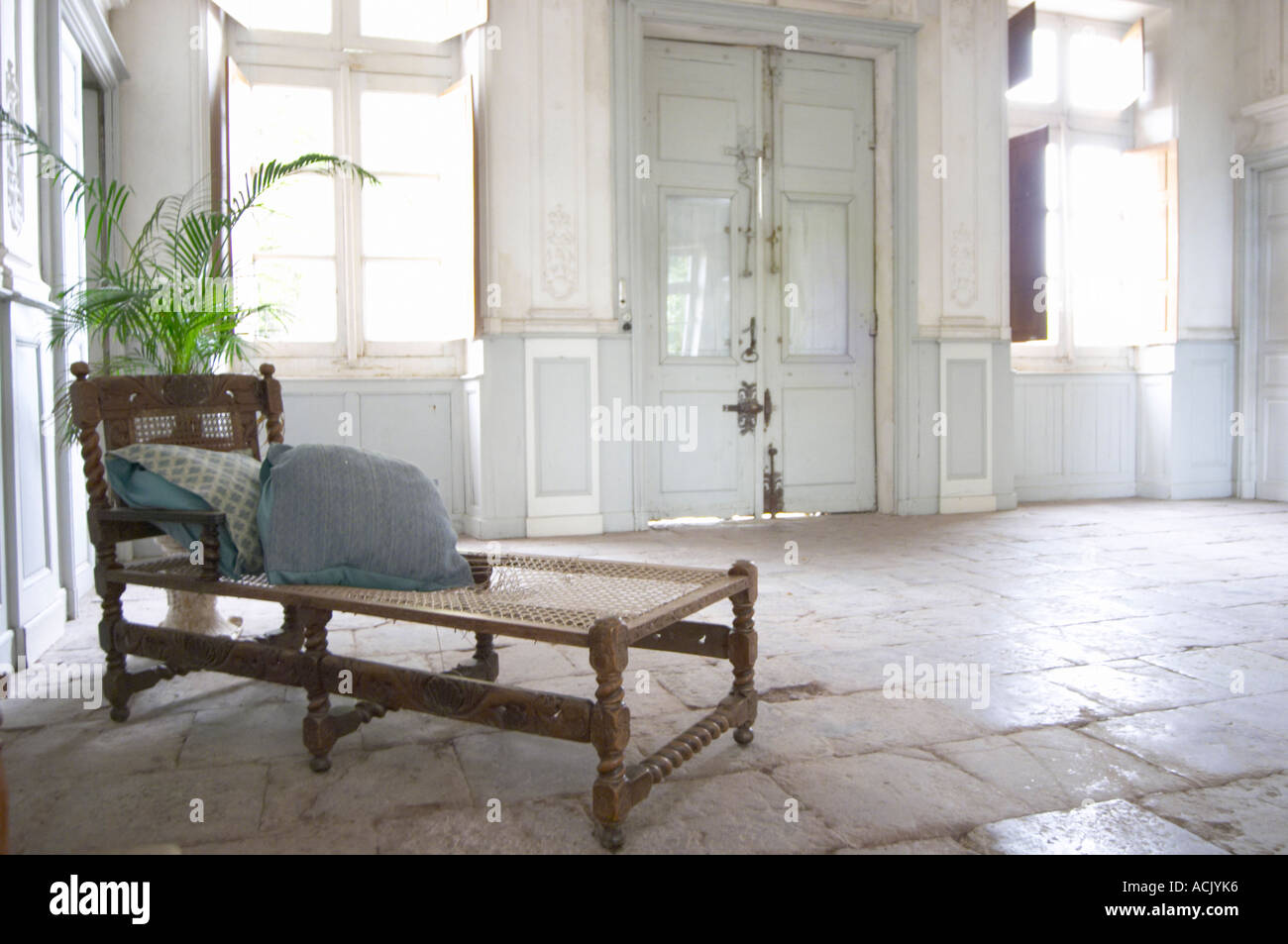 In the stately entrance hall: An old lounging chair chaise longue with ...