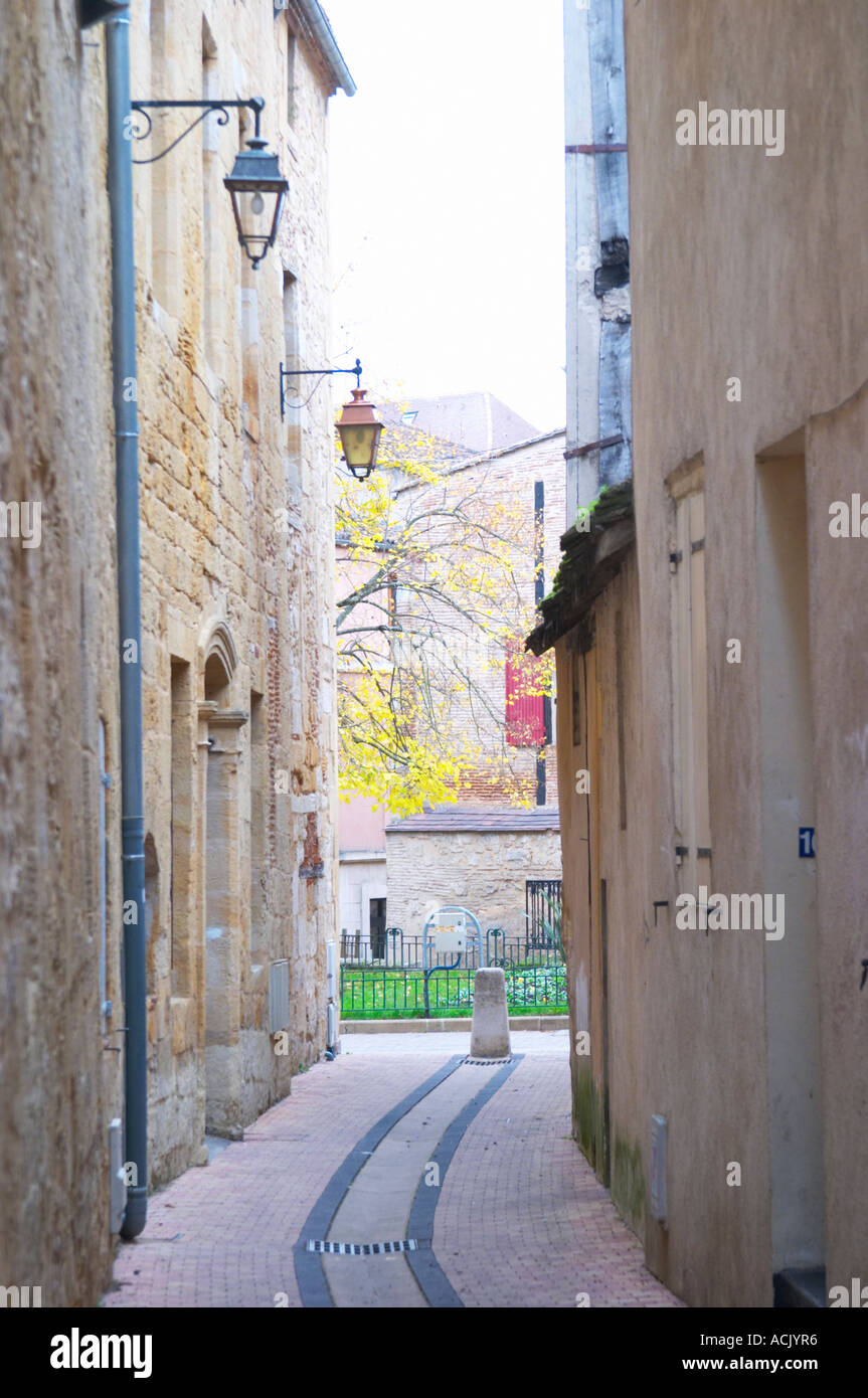 A curving street in the old town with old stone houses, leading to the ...