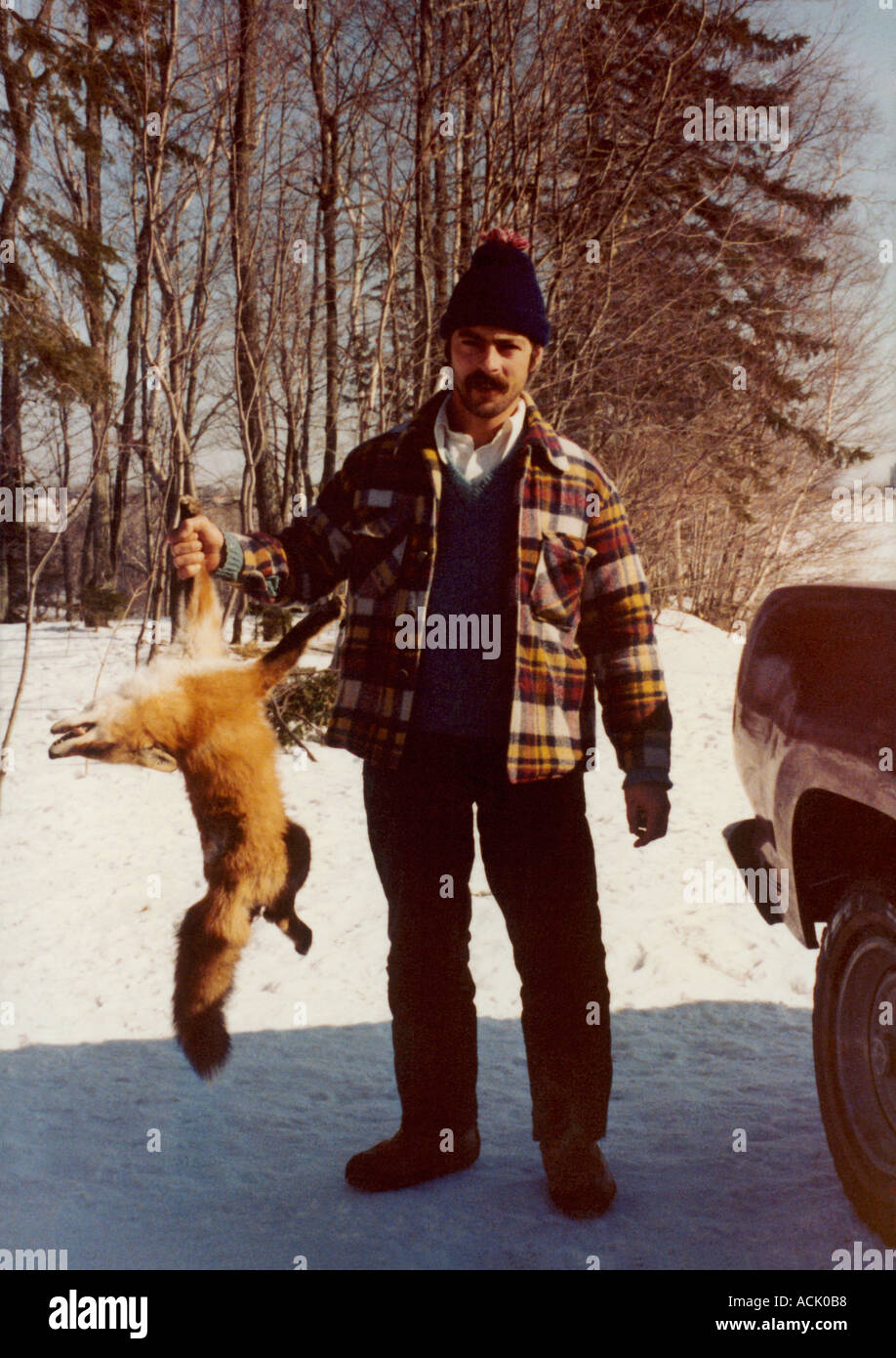 A man holding a dead fox Stock Photo - Alamy