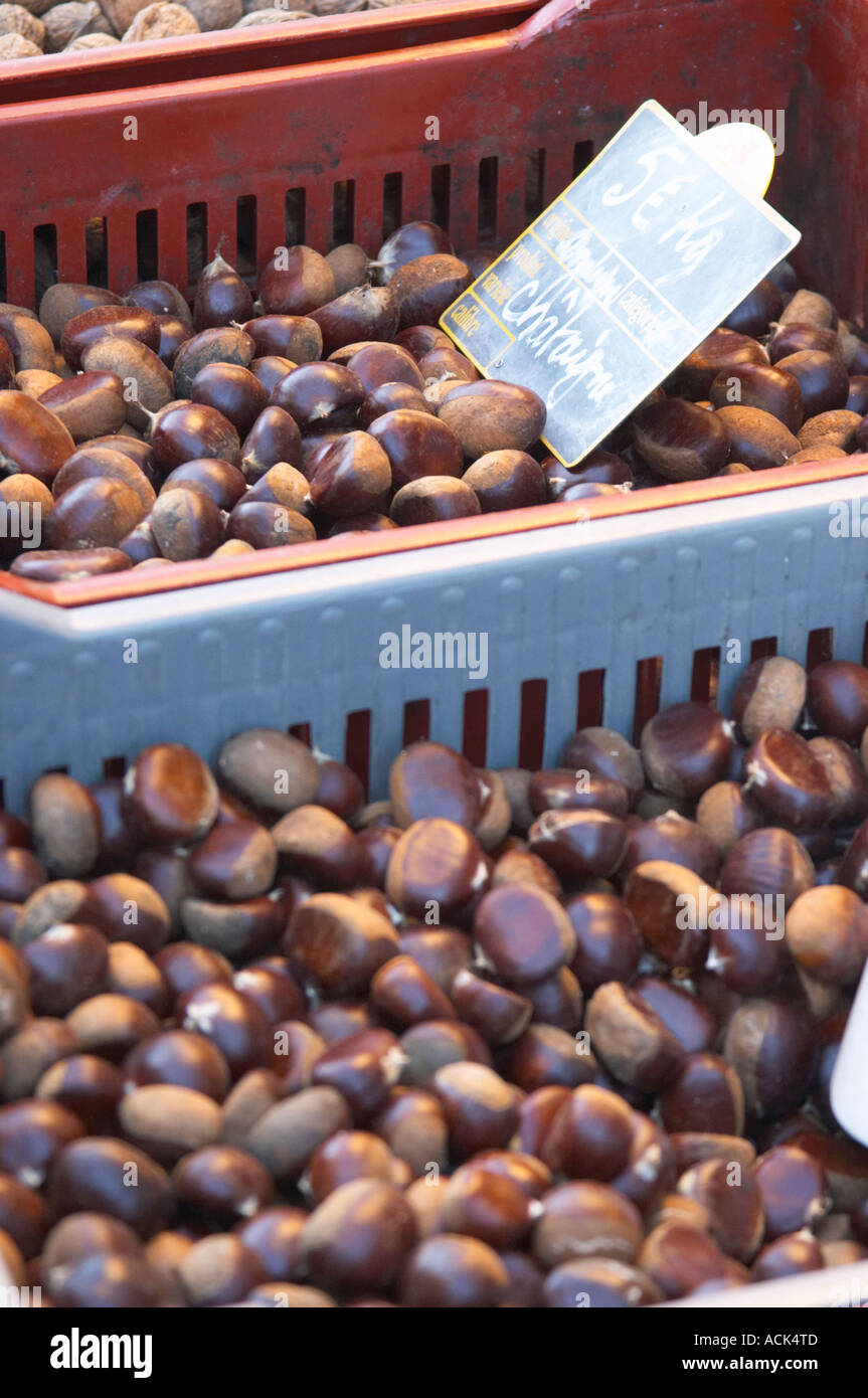 Chestnuts for sale at a market stall at the market in Bergerac in a red ...