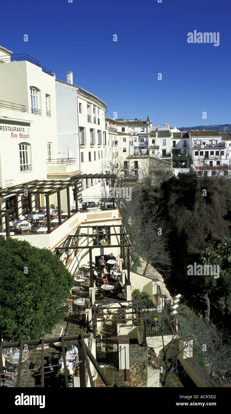 People eating on balconies of houses in hilltop village Ronda Andalucia ...