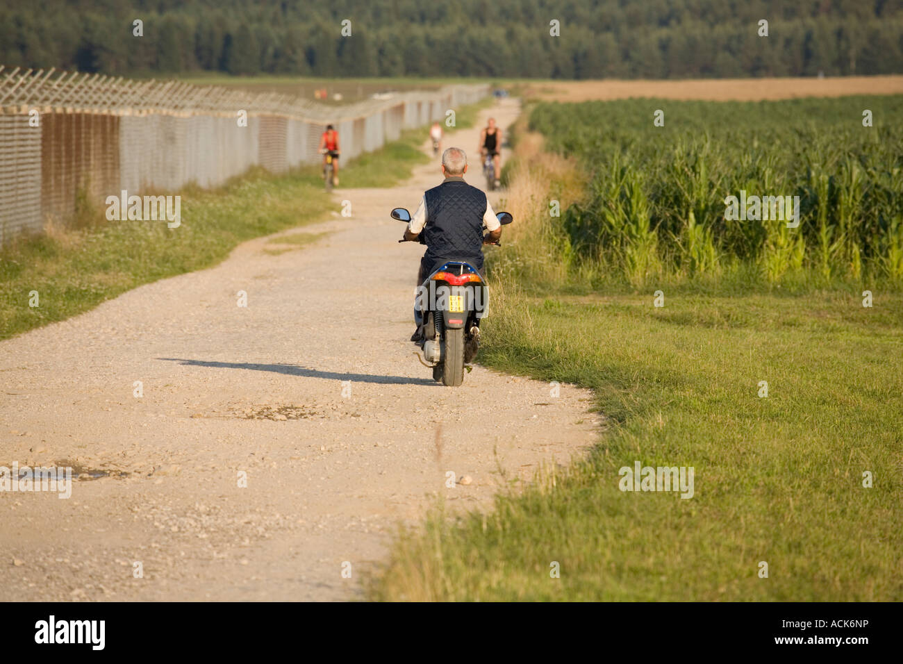 Man riding moped beside Ljubljana airport, Slovenia Stock Photo - Alamy