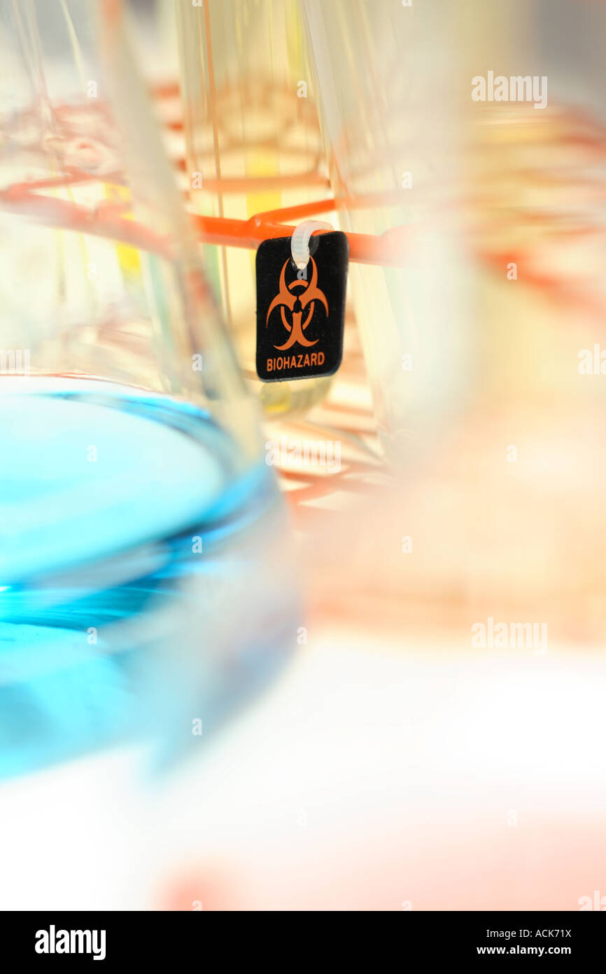 Laboratory glassware with biohazard label Stock Photo - Alamy