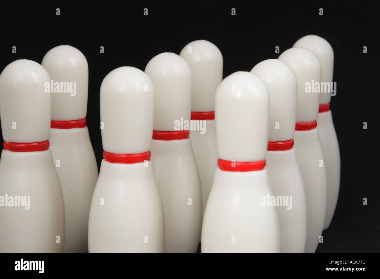 Toy plastic bowling pins on black background Stock Photo - Alamy