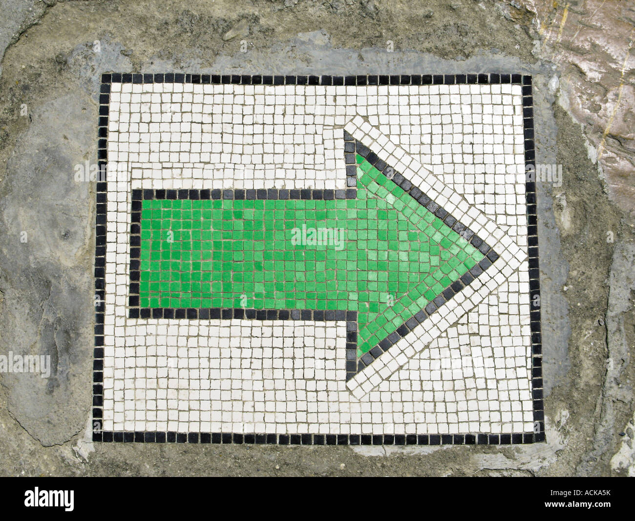 Green arrow mosaic tile sign Stock Photo - Alamy