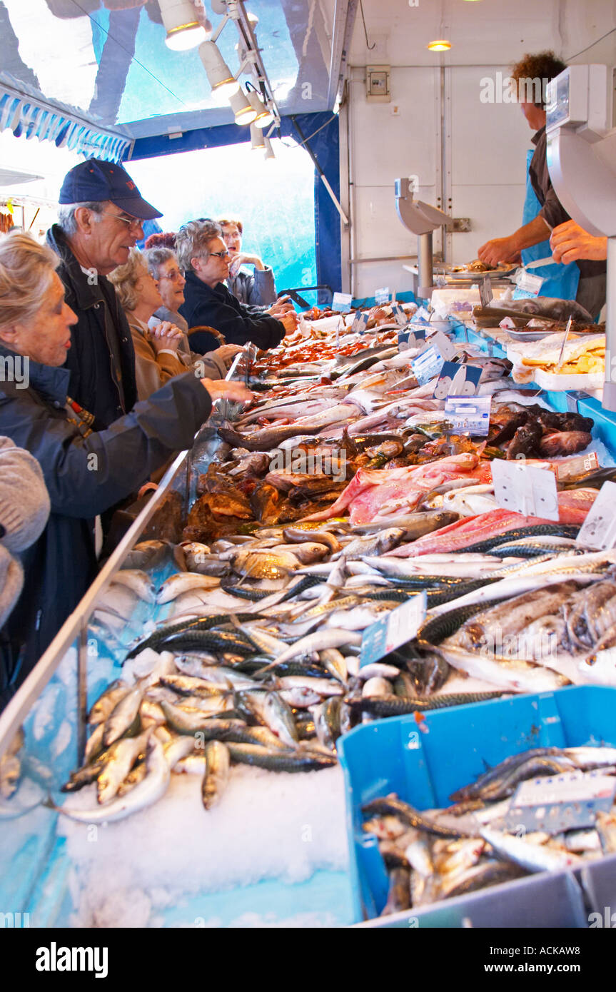 Street market merchant's stall with many different type of fish ...