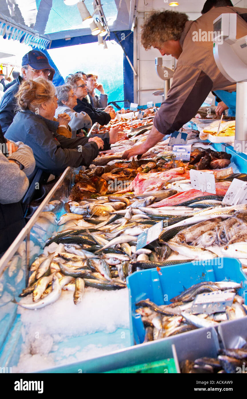 Street market merchant's stall with many different type of fish ...