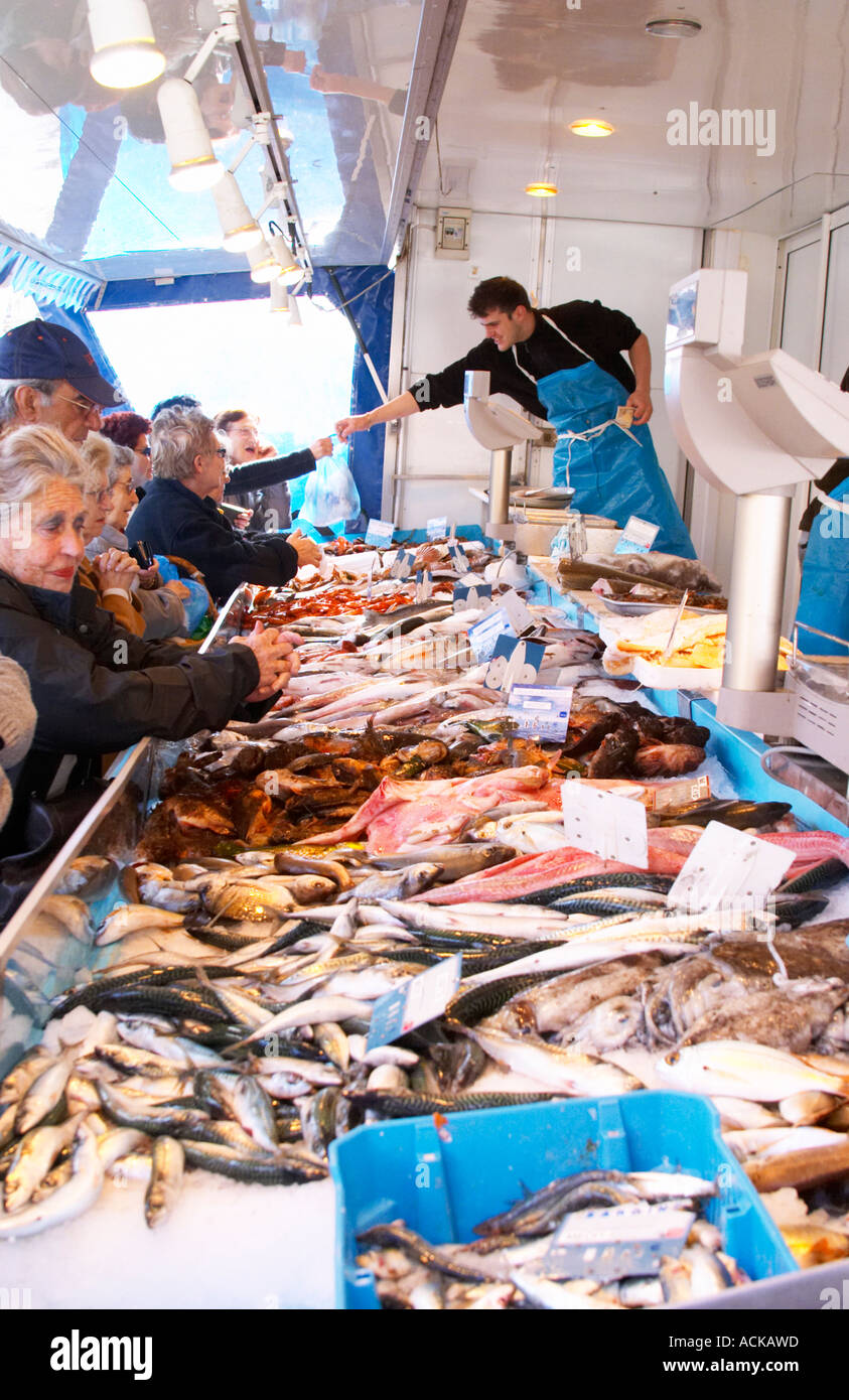 Street market merchant's stall with many different type of fish ...