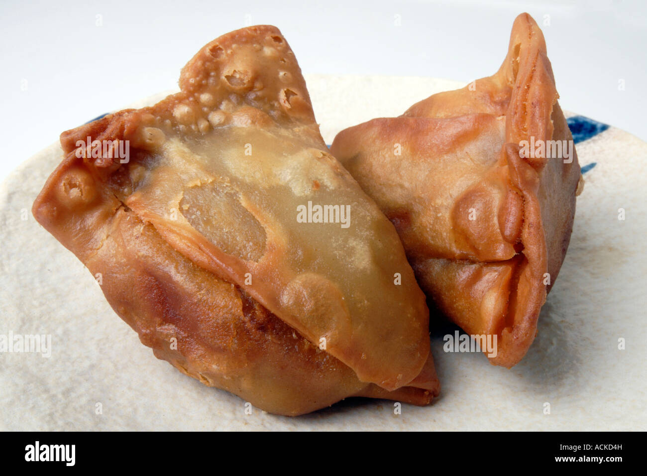 Two fried Samosa on a plate Stock Photo - Alamy