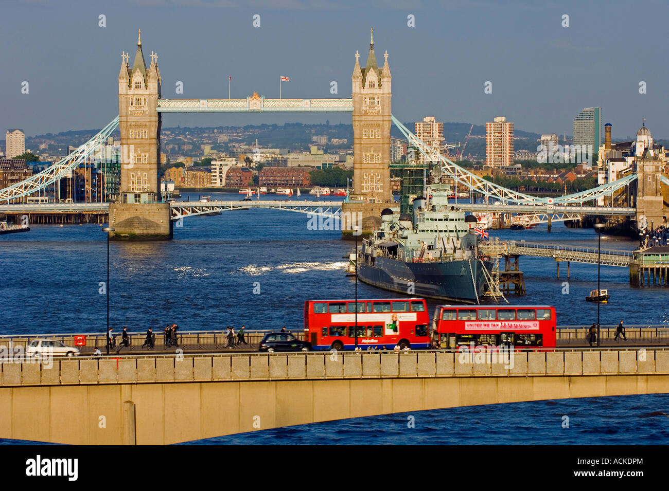 Buses crossing London Bridge with Tower Bridge in background Stock ...