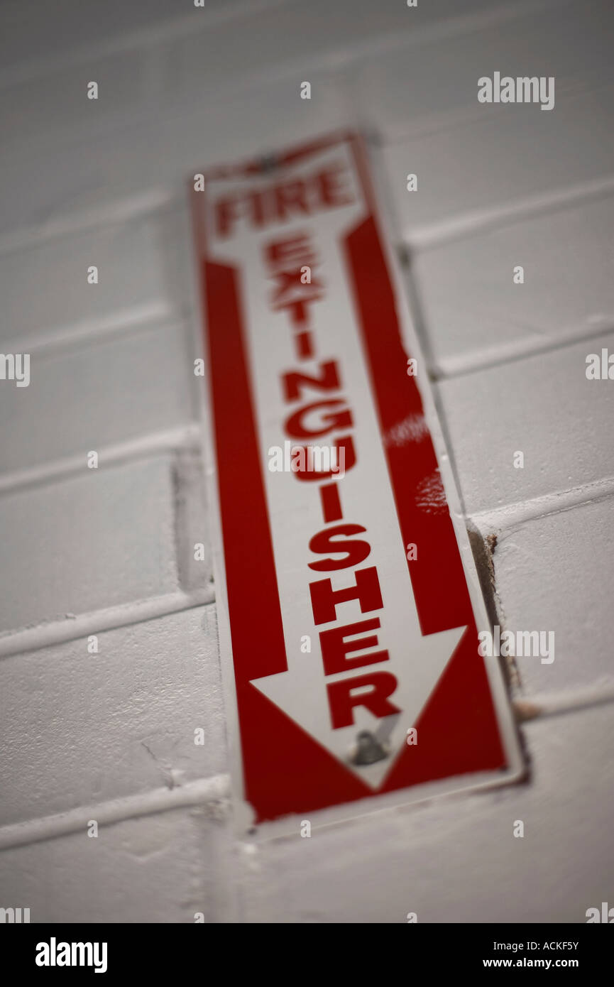 Fire extinguisher sign arrow bolt brick wall white red emergency hi-res ...