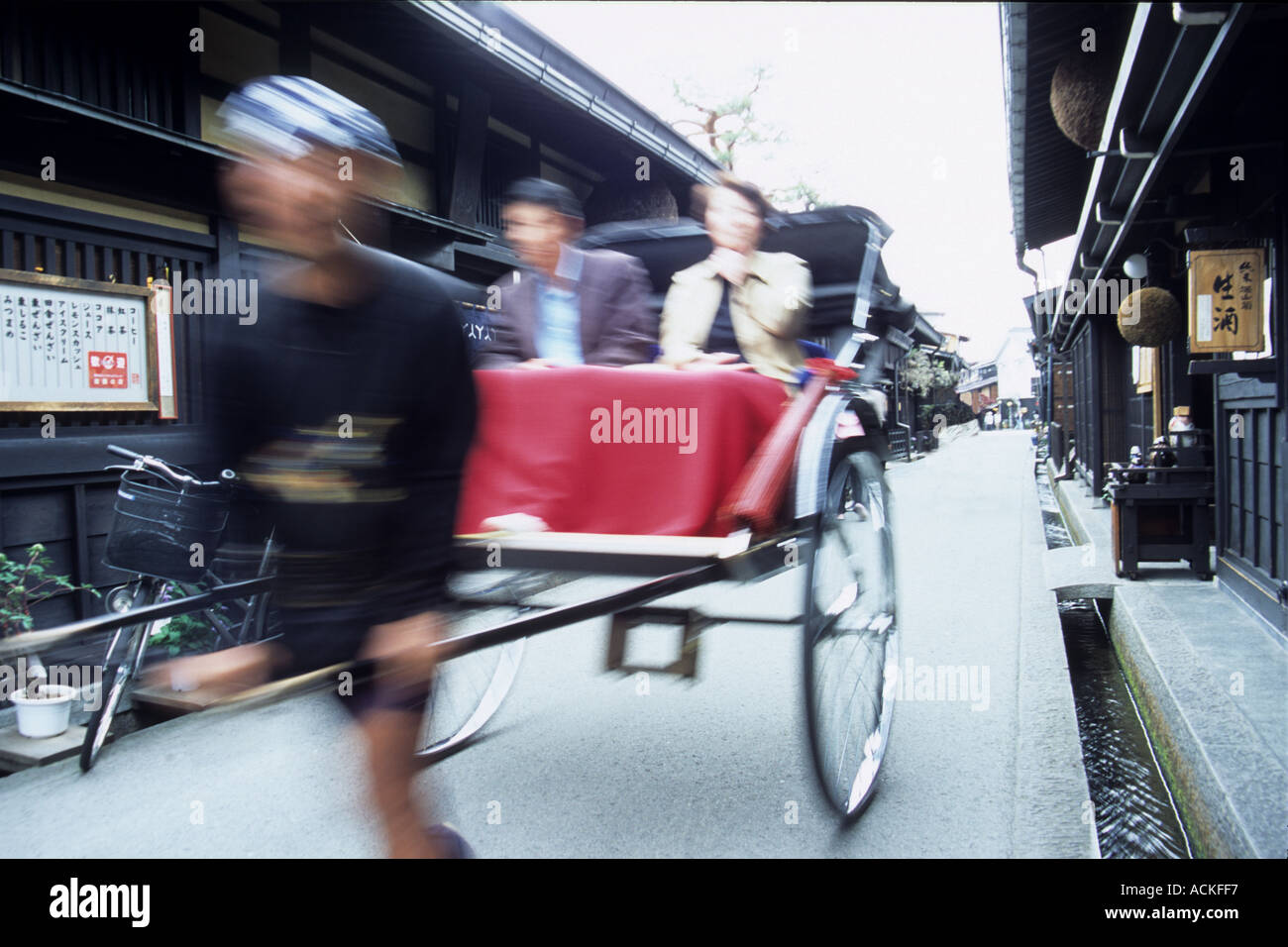 Japanese man pulling rickshaw with tourists hi-res stock photography ...