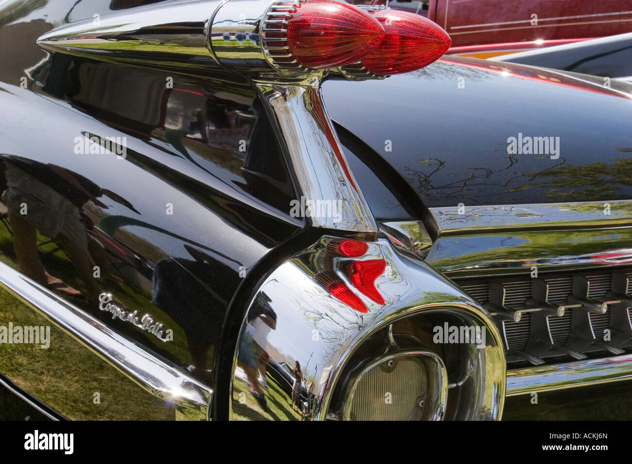 Chrome fins and tail lights at the back of a black 1959 Cadillac Coupe ...