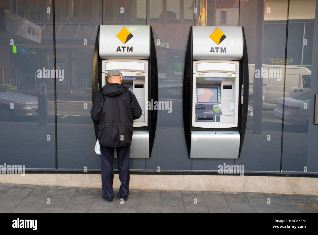 Man using an Australian Commonwealth Bank automatic teller machine ...