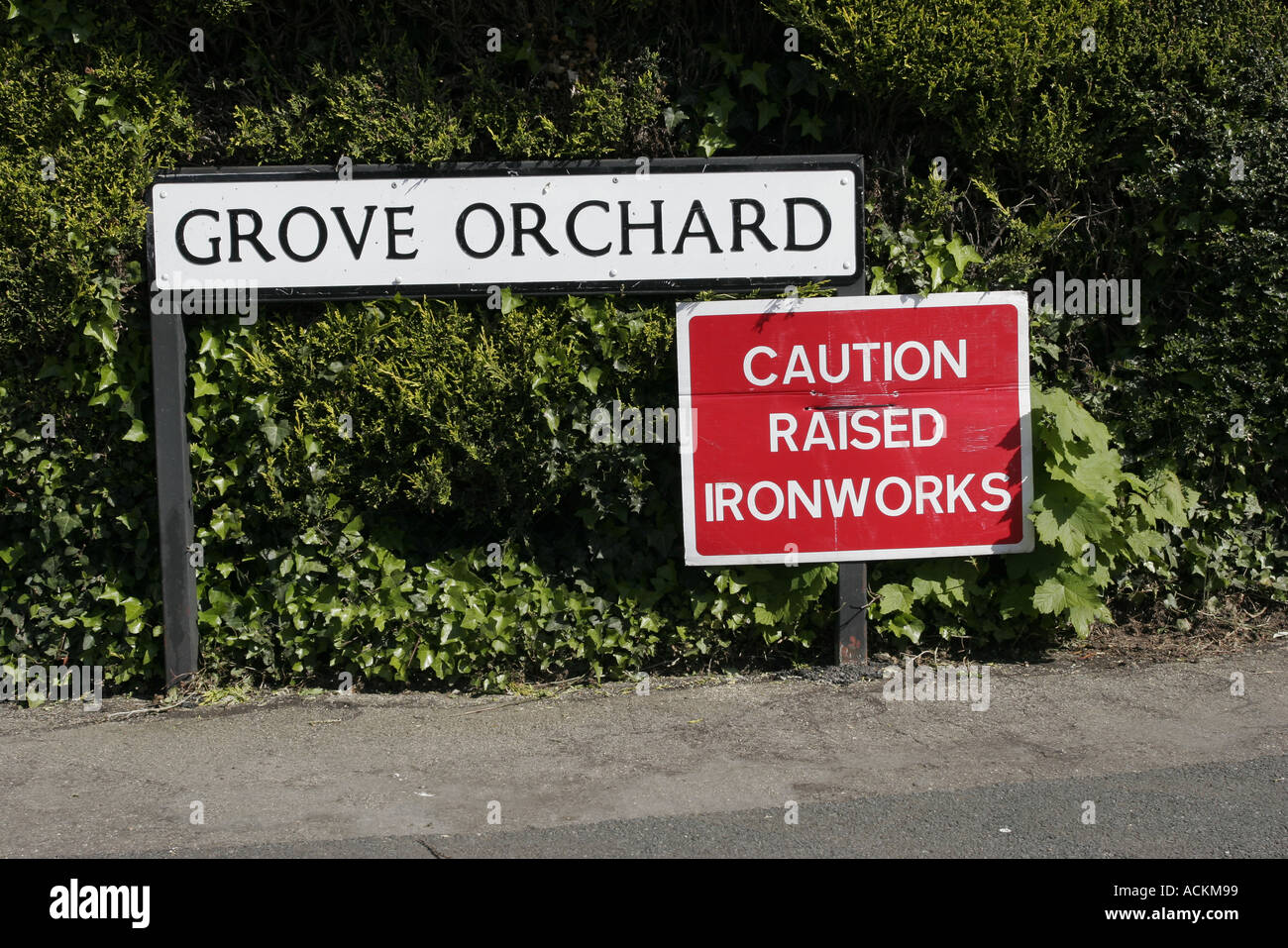 Road sign and warning of raised manholes during roadworks Stock Photo ...