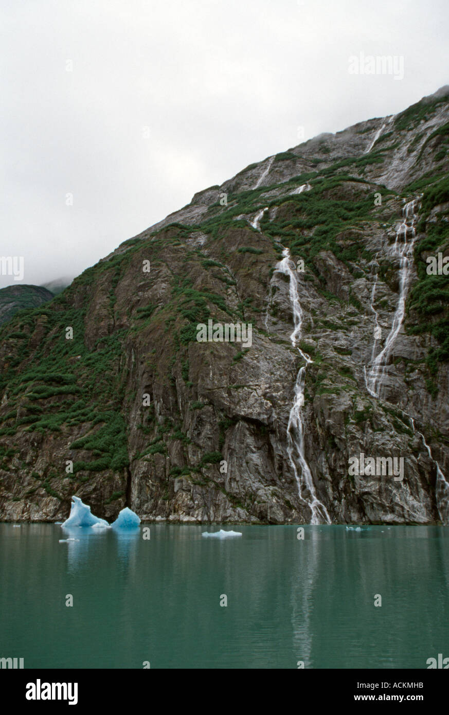 Alaska waterfalls on rock facing water Stock Photo - Alamy